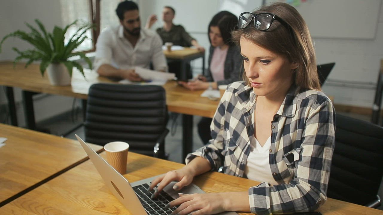 Digital marketing pro works on laptop and smiles - Free Stock Video