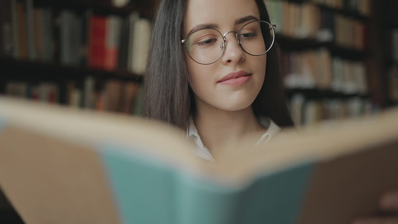 Smart girl thinking while reading book - Free Stock Video