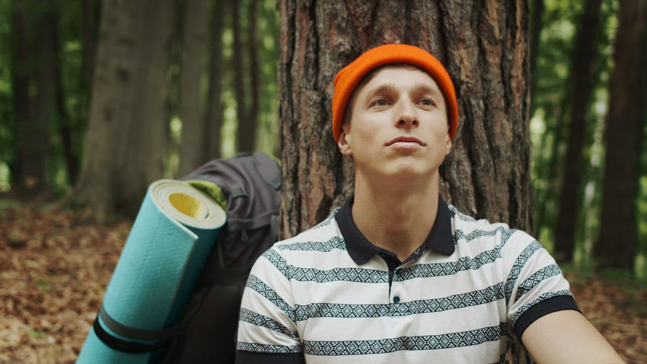 Man resting in a forest with hopeful attitude - Free Stock Video