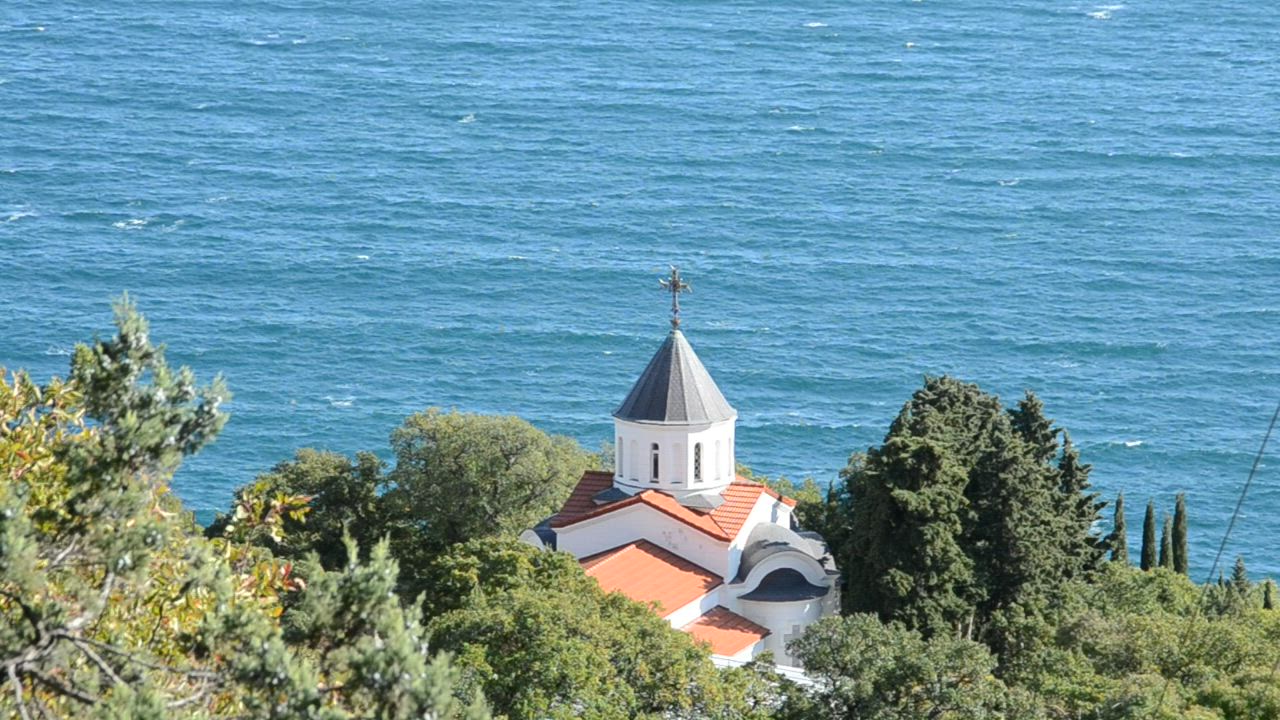 Dome of a church near the sea, from afar - Free Stock Video