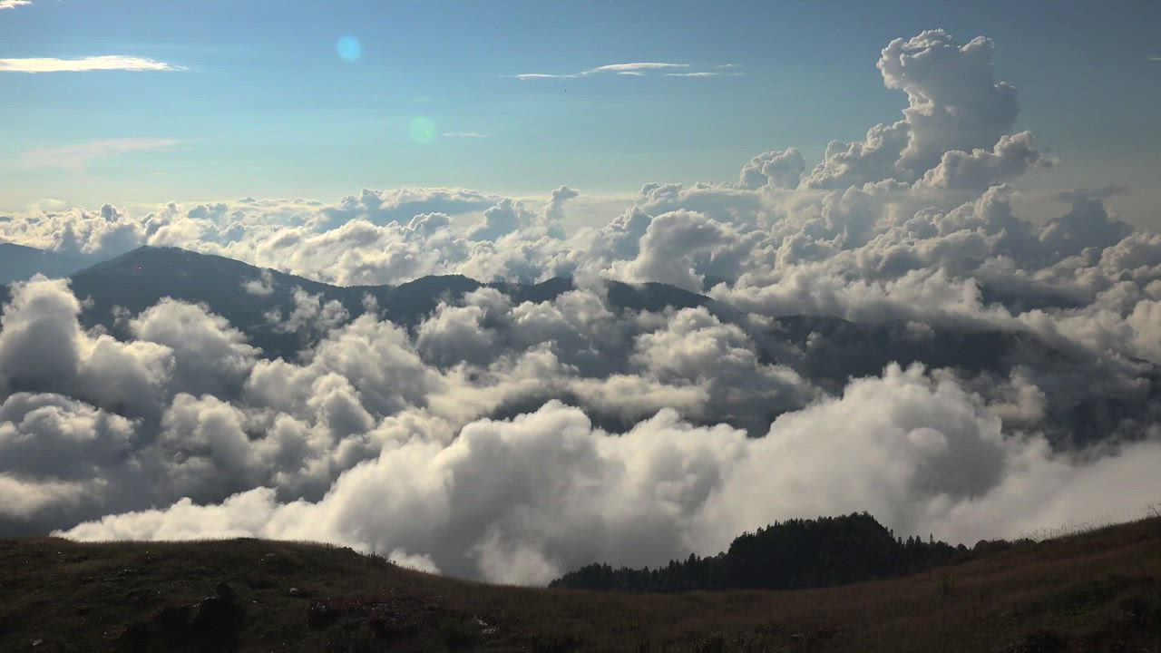 Clouds moving above the mountains - Free Stock Video