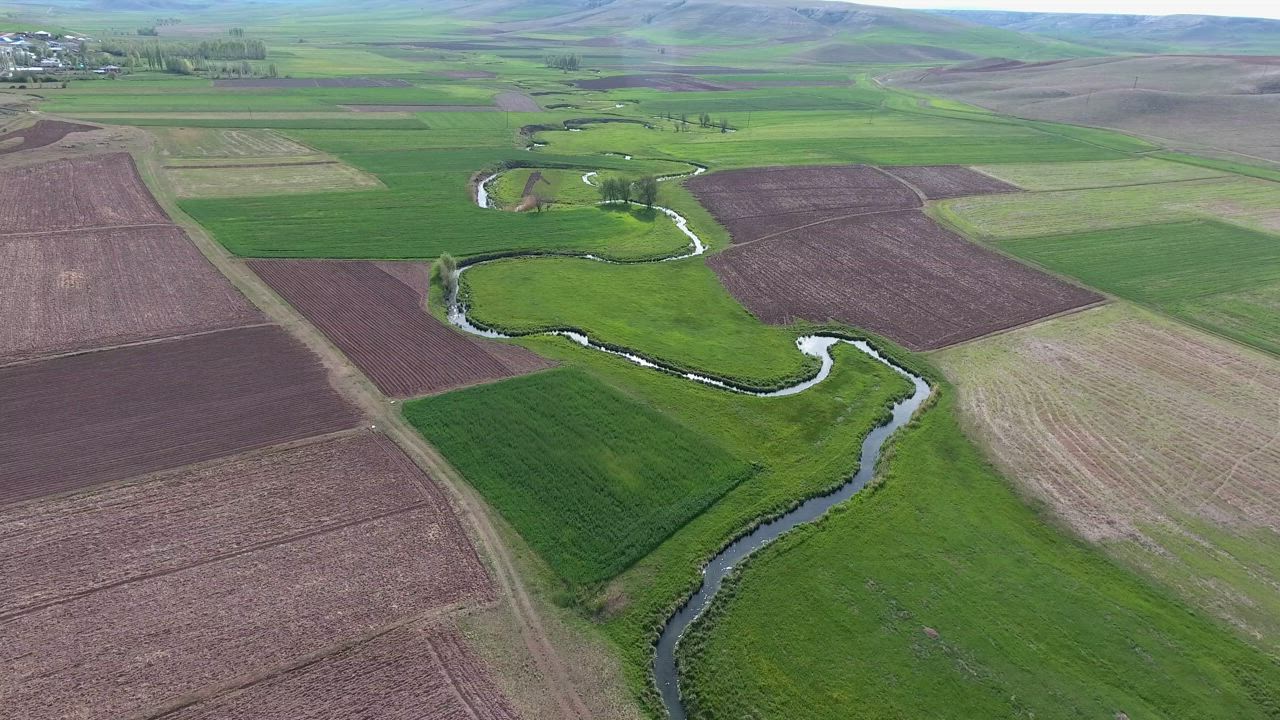 A small river and crop fields - Free Stock Video