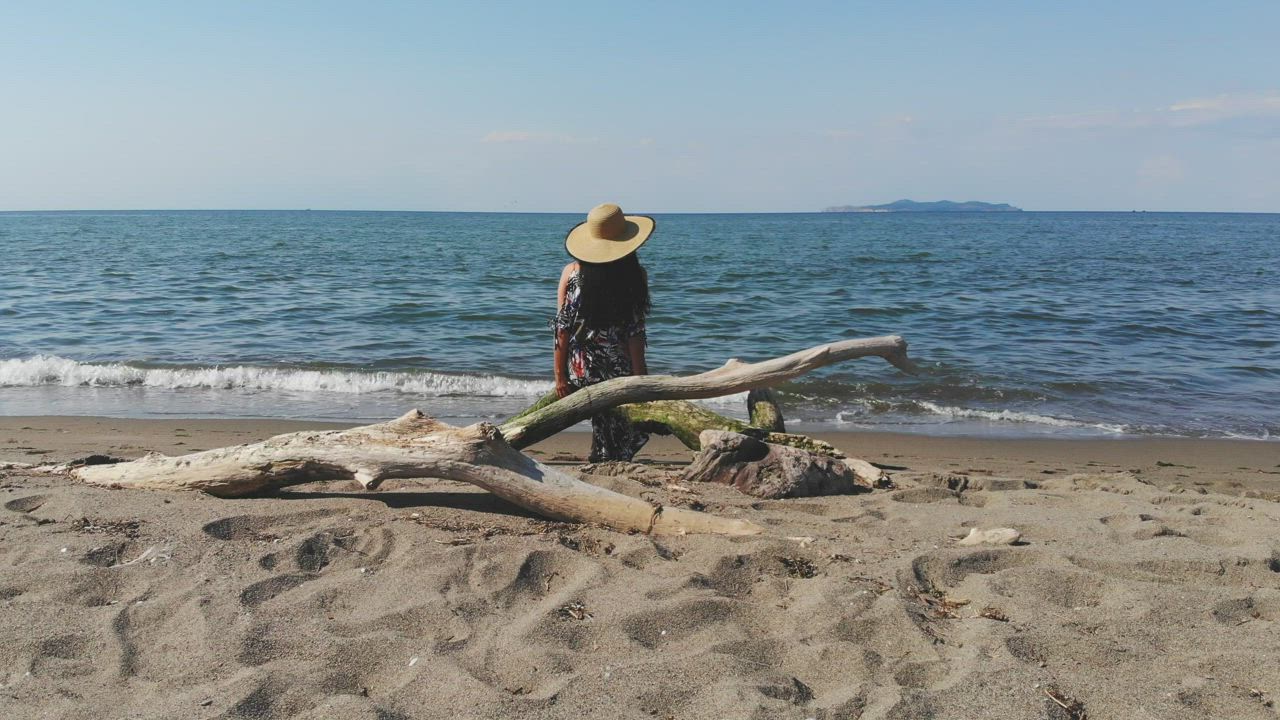 Woman contemplating the ocean - Free Stock Video